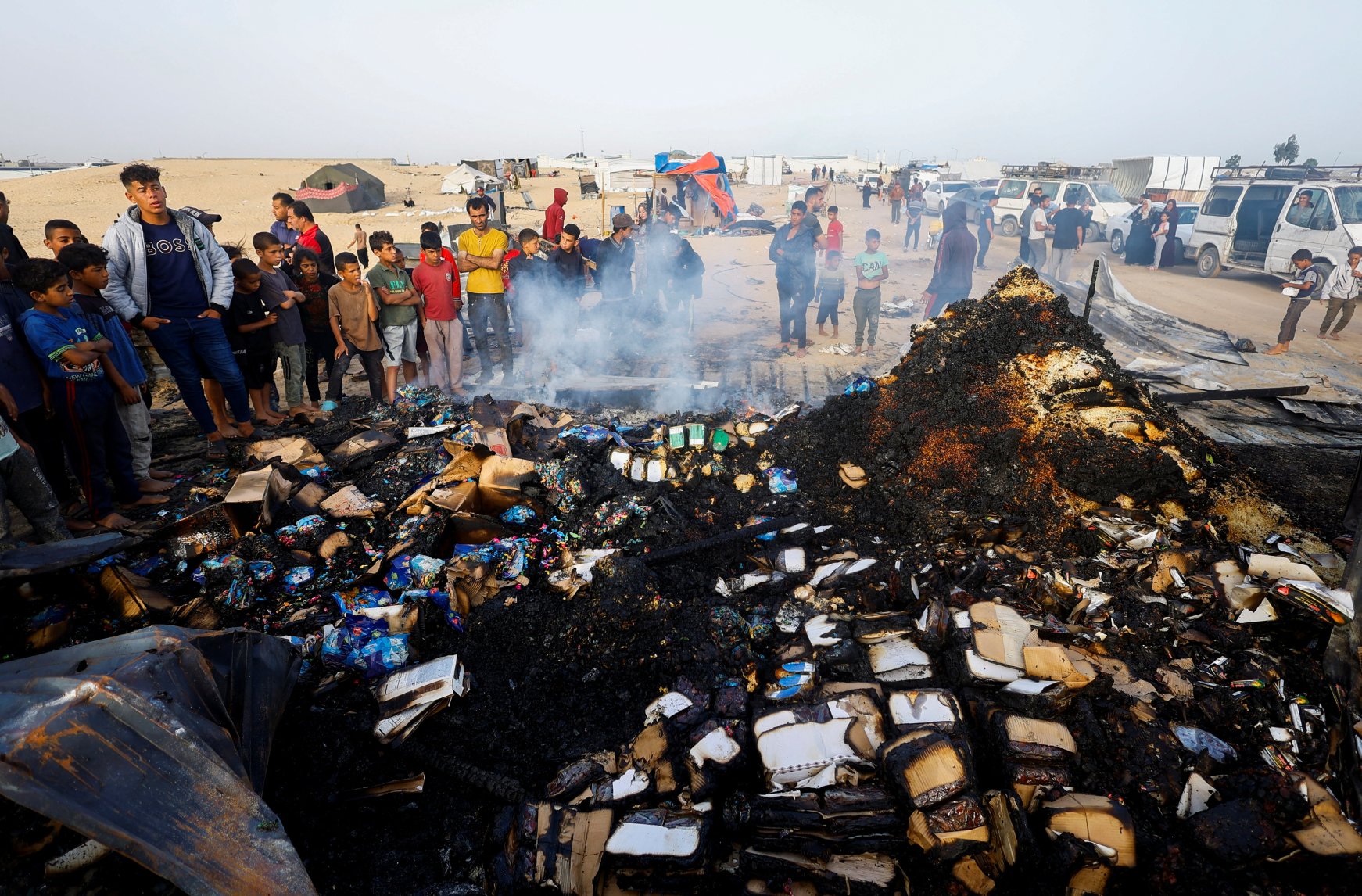 Children look for food amid ashes in Rafah after Israeli camp massacre ...